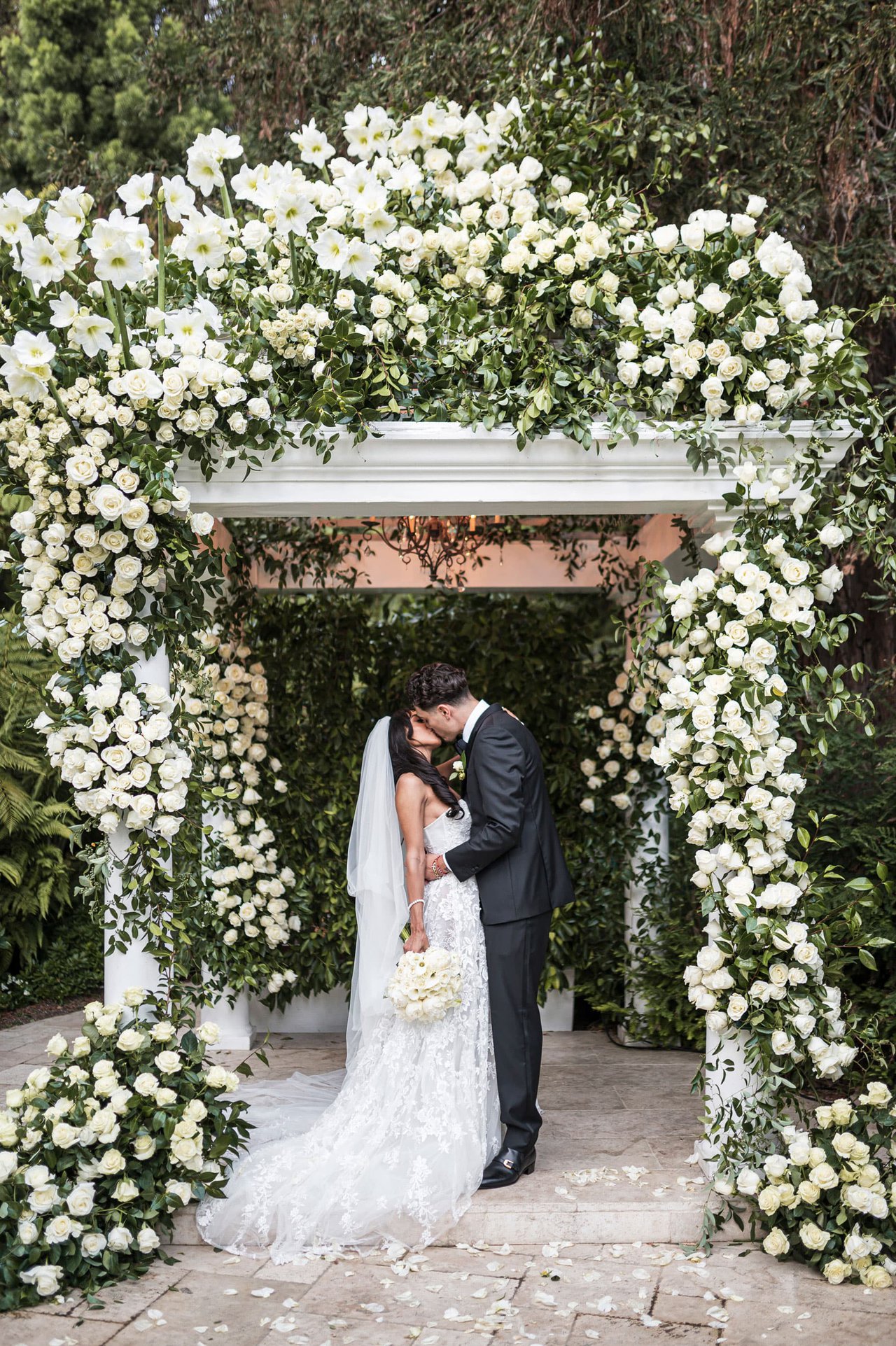 Bride & Groom Kissing Under Arch