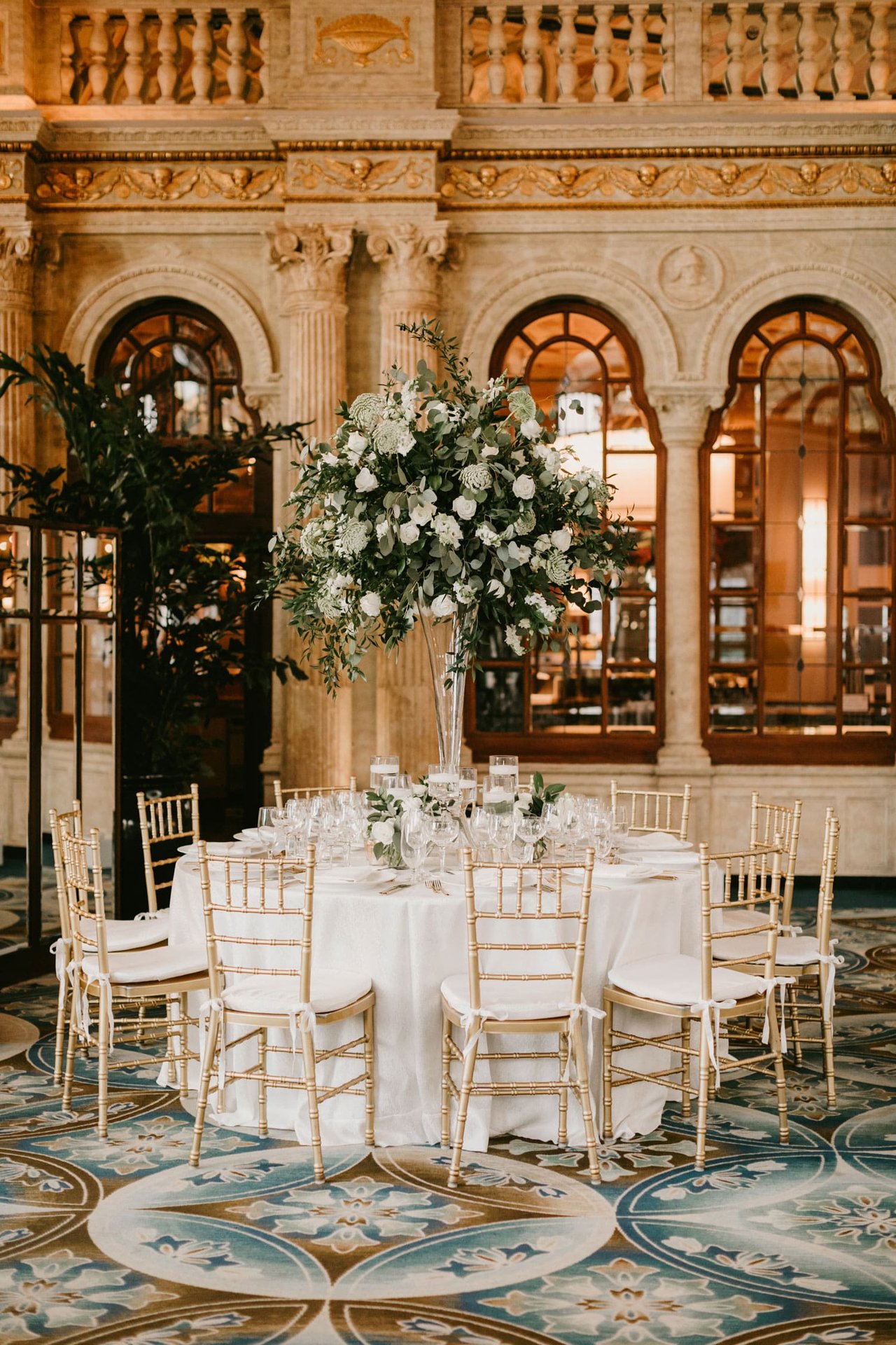 Tall Centerpiece at Round Table with Gold Chairs