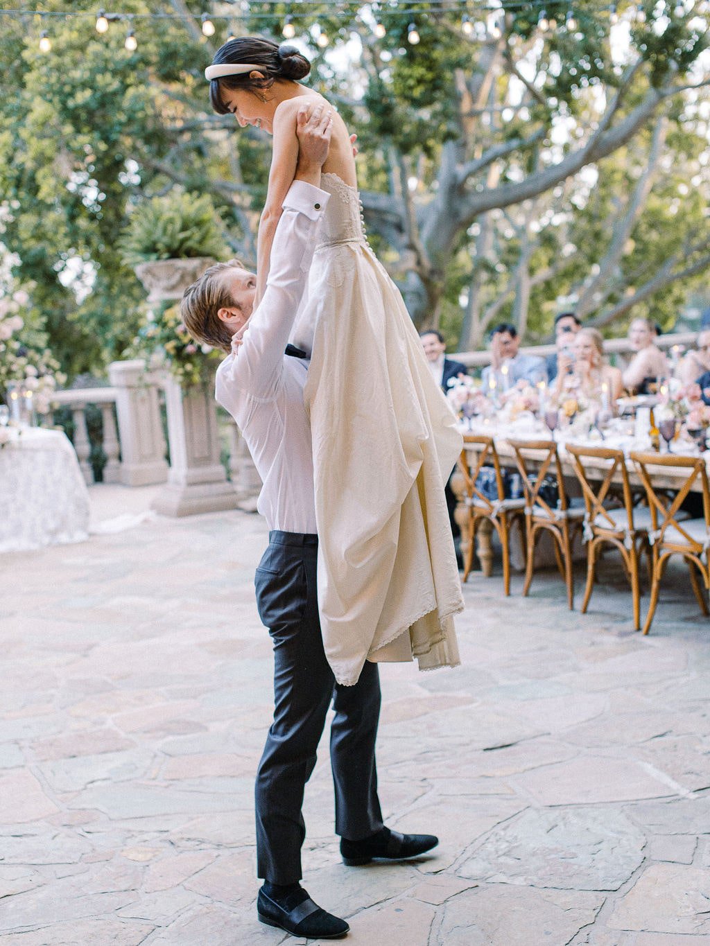 Groom Lifts Bride During First Dance