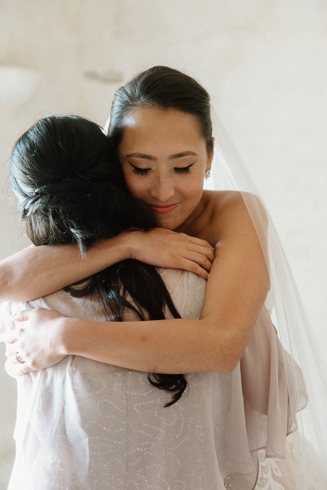 Bride Hugging Mother Of The Bride