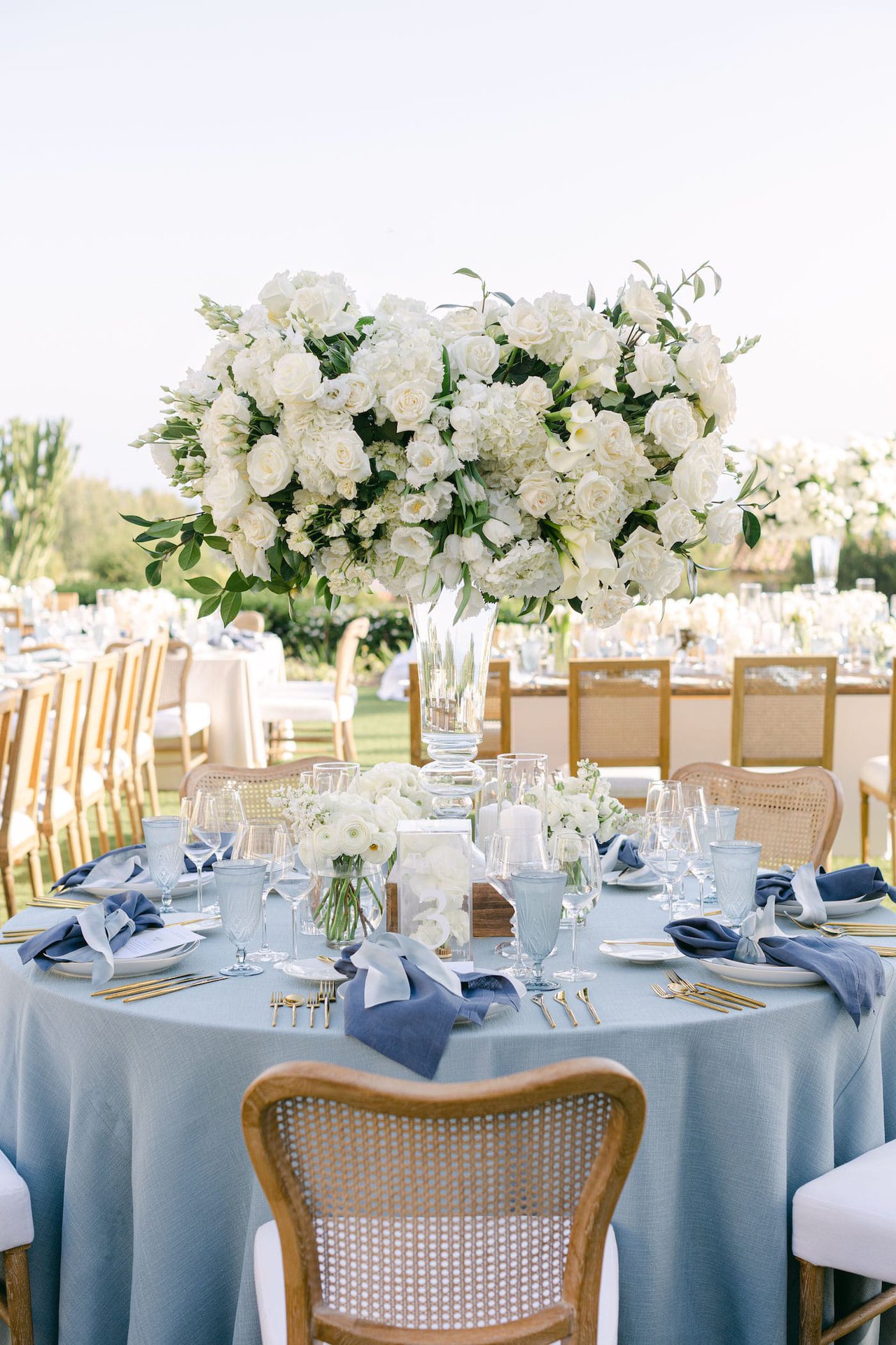 Blue Linens & White Centerpieces - The Hidden Garden