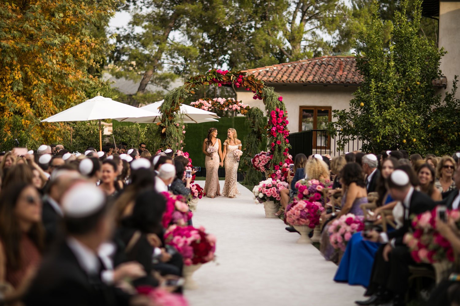 Bridesmaids Walking Through Arch