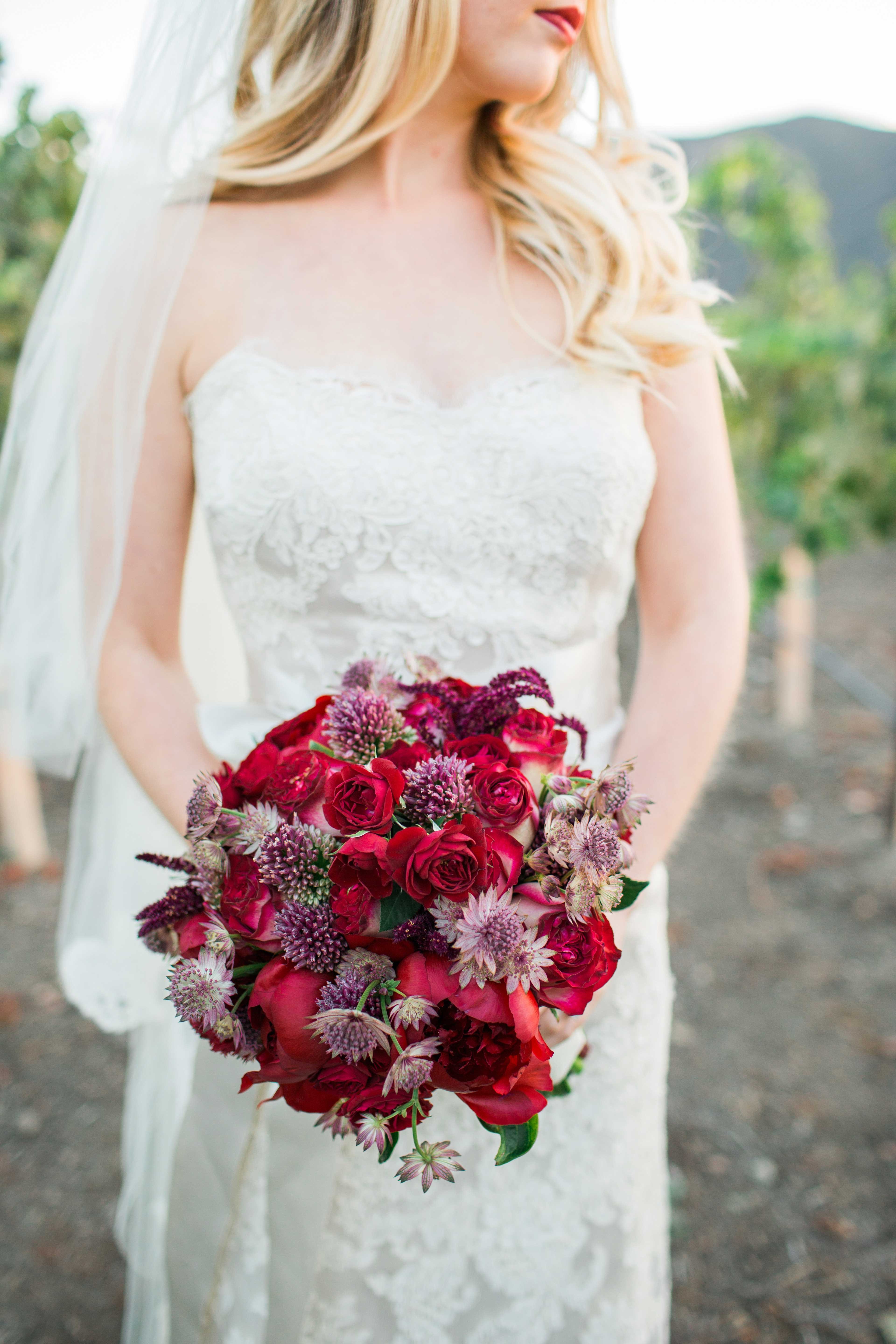 Bride Holds Red, Pink, and Purple Bouquet