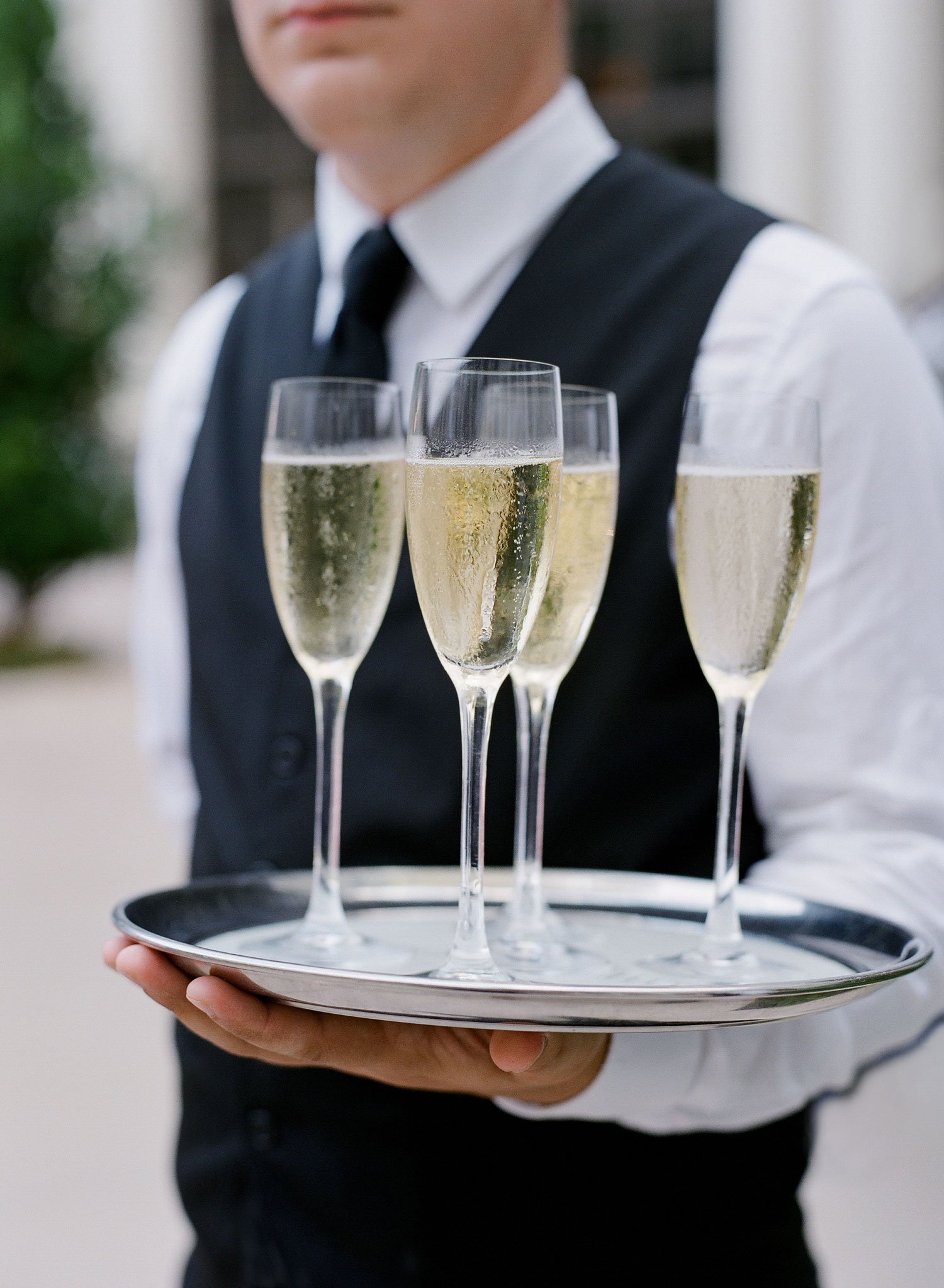 Server with Glasses of Champagne