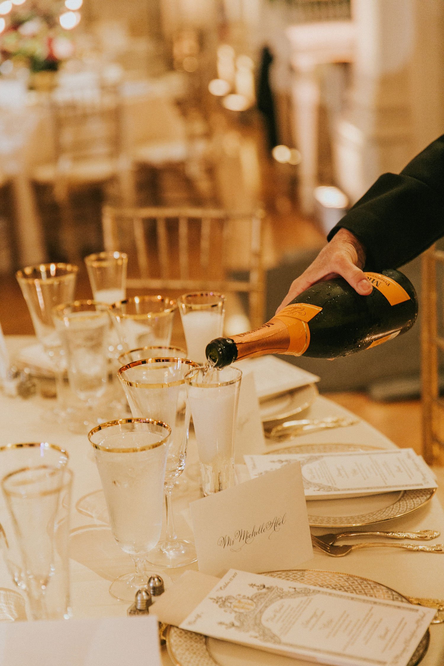Server Pouring Champagne at Reception