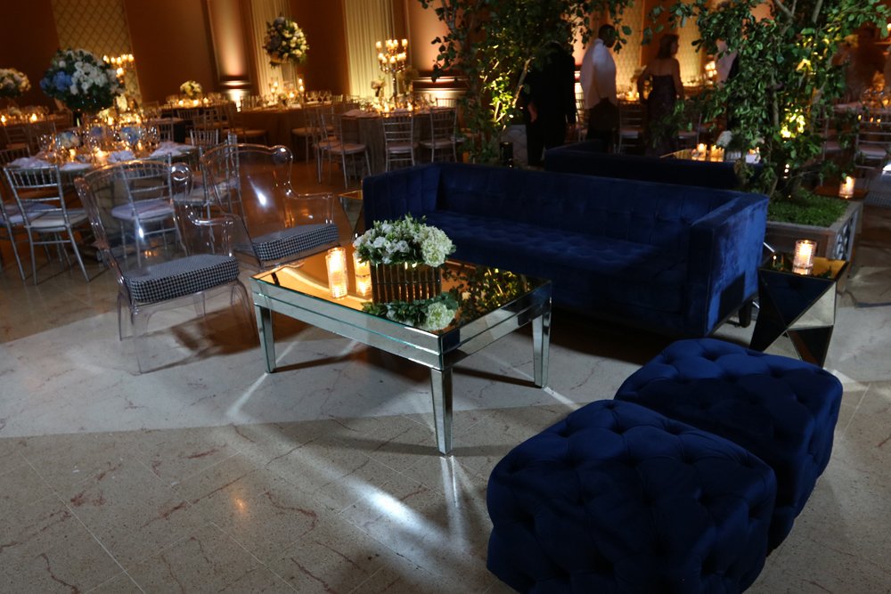 Dimly Lit Lounge Space, Navy Couch, Reflective