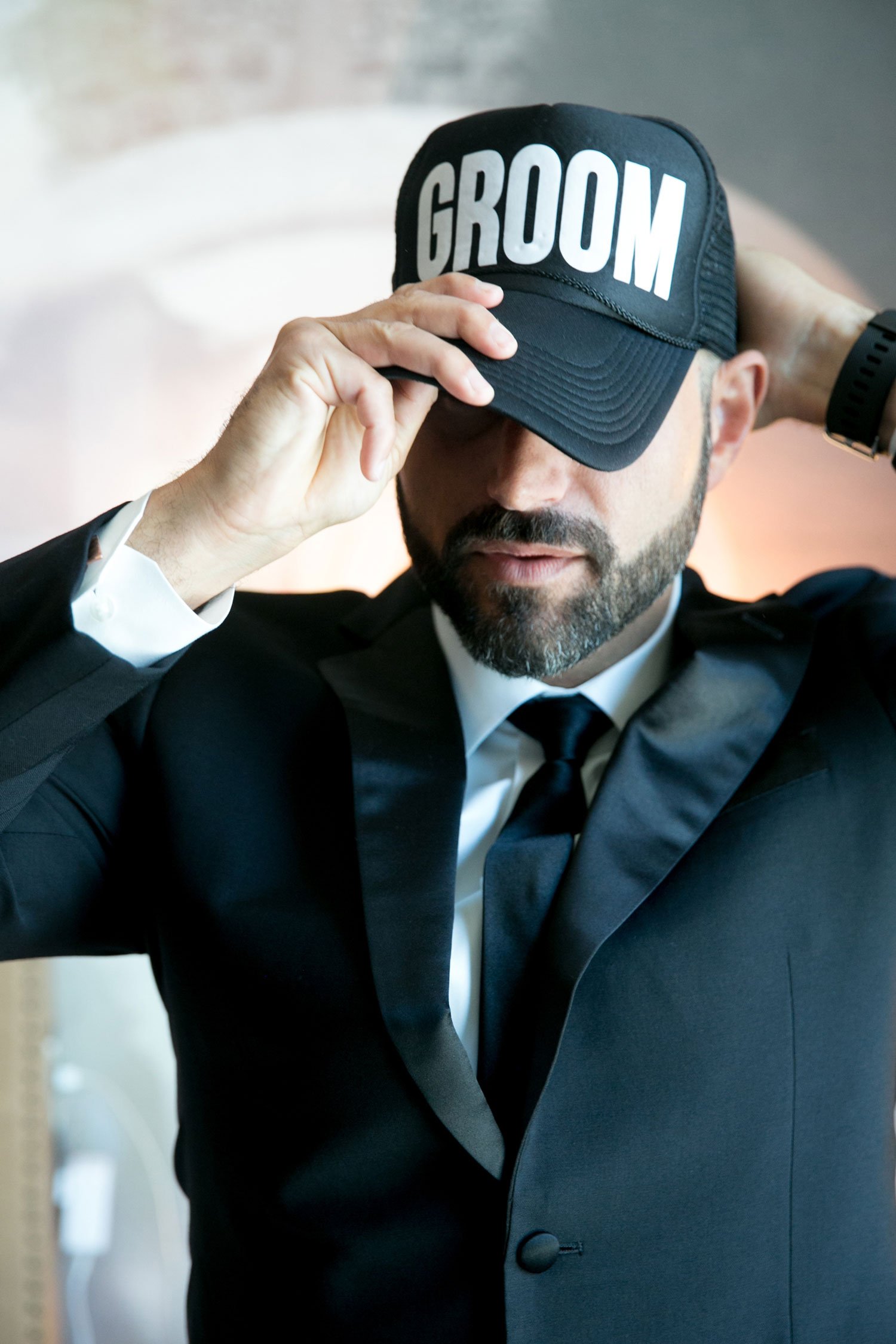 Groom Putting on "Groom" Hat